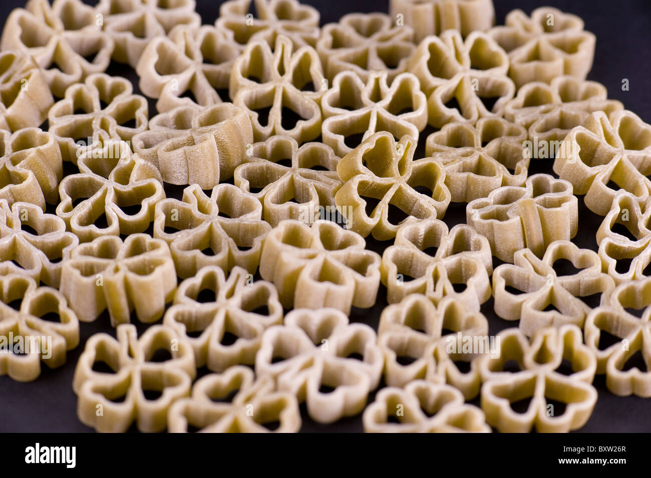 Macaroni on black background Stock Photo - Alamy
