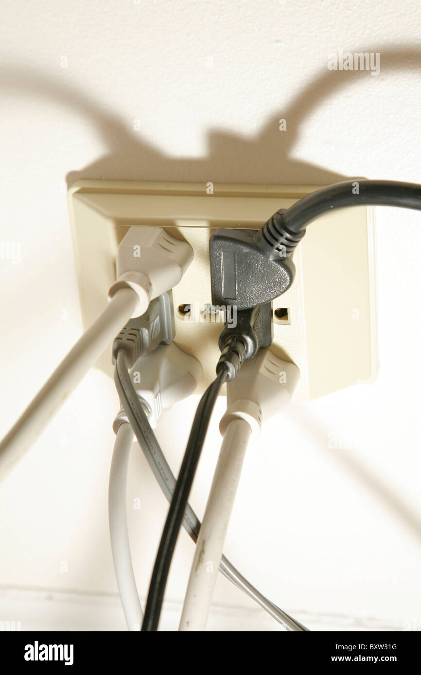 Multiple power cords plugged into an American 120 volt electric outlet ...