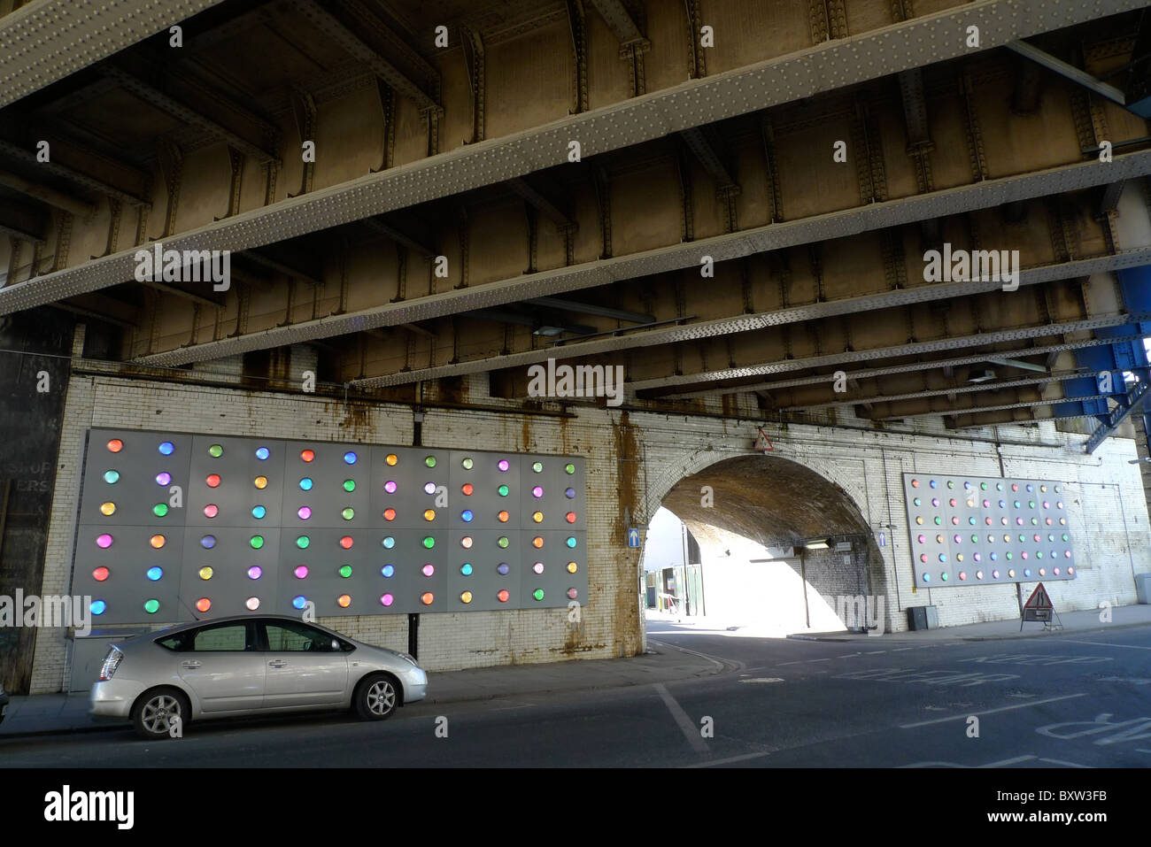 Toyota Prius hybrid eco friendly car under bridge with multi coloured ...