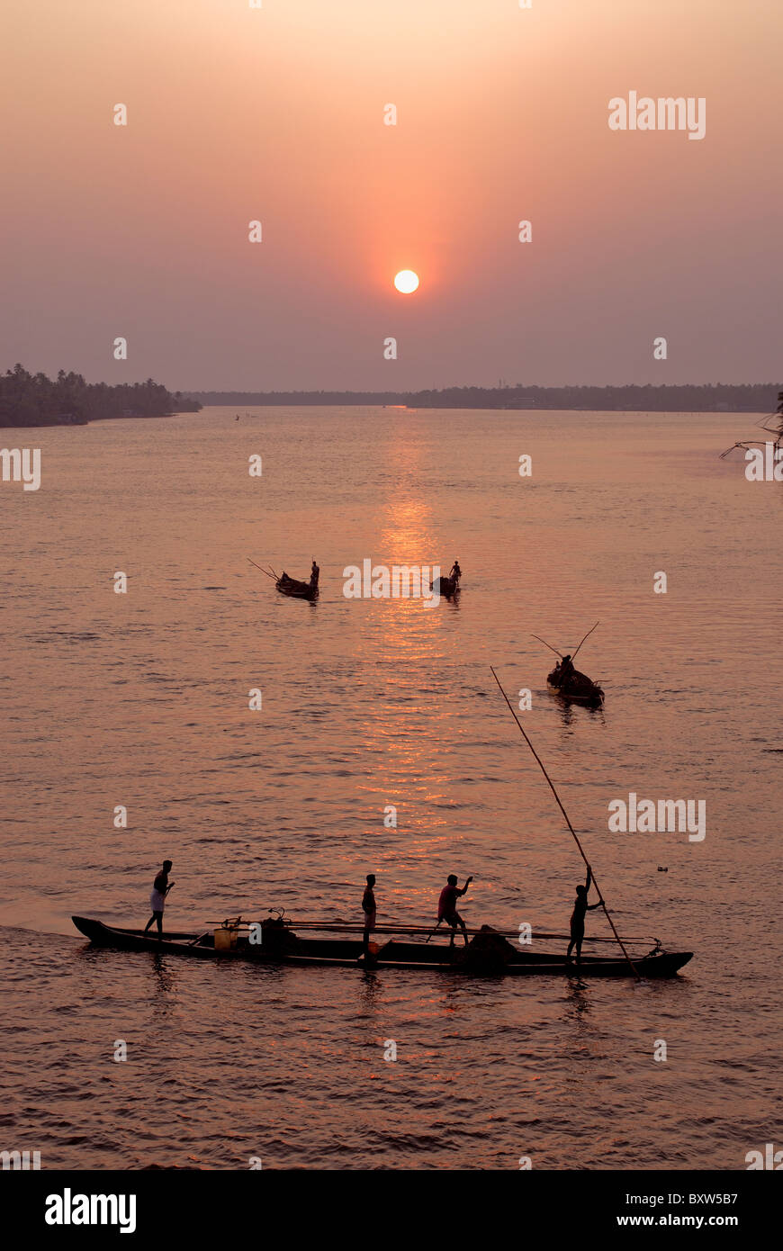 COLLECTING SAND AT SUNSET KERALA Stock Photo - Alamy
