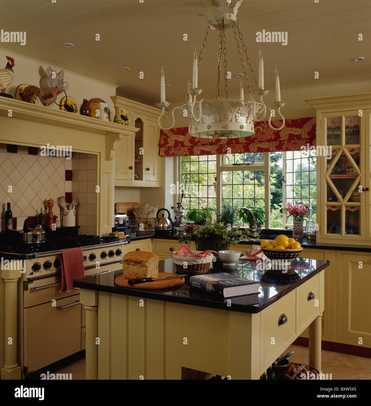 Cream metal candelabra above granite-topped island unit in traditional ...