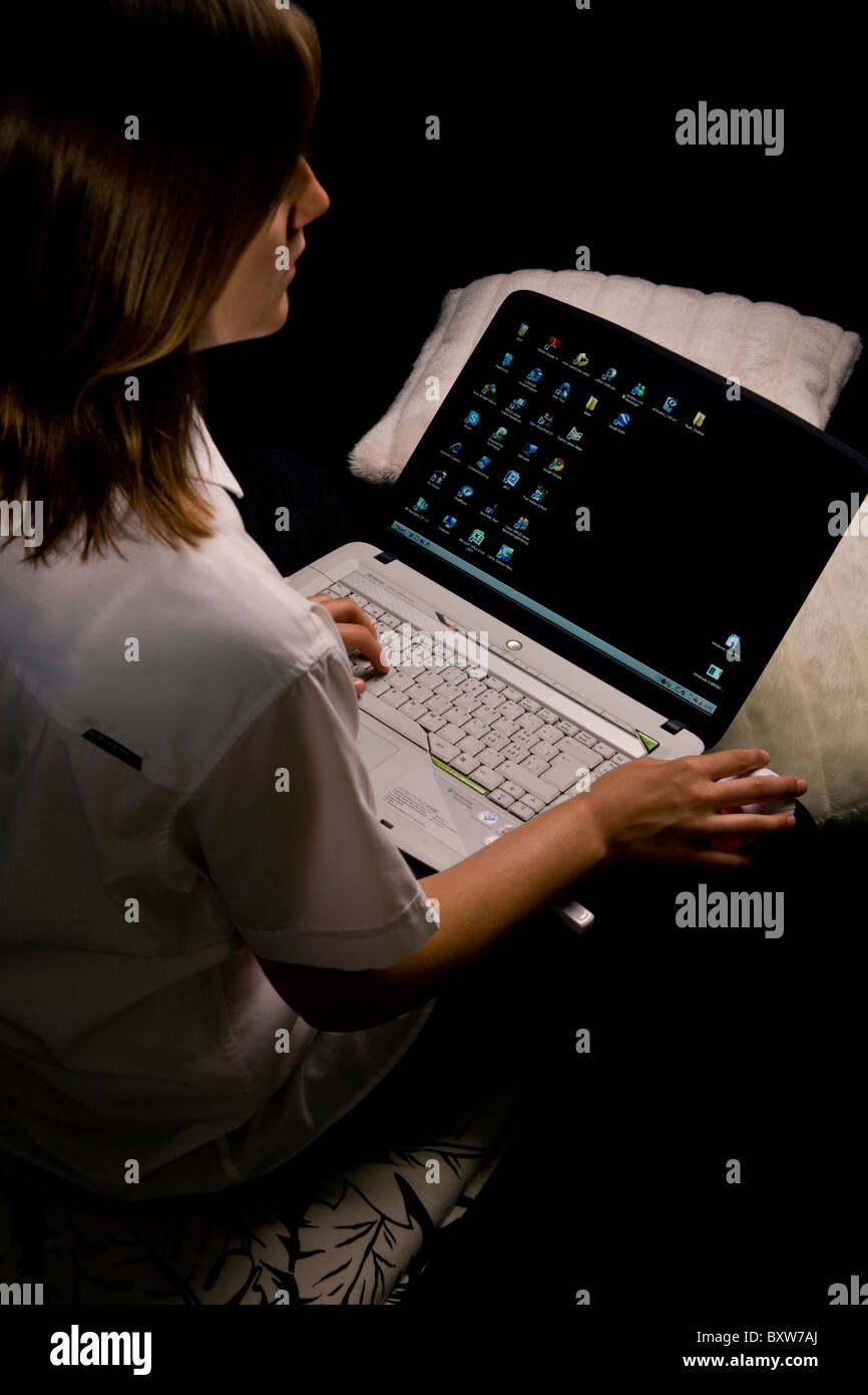 A young girl woman studying on her white laptop computer Stock Photo ...