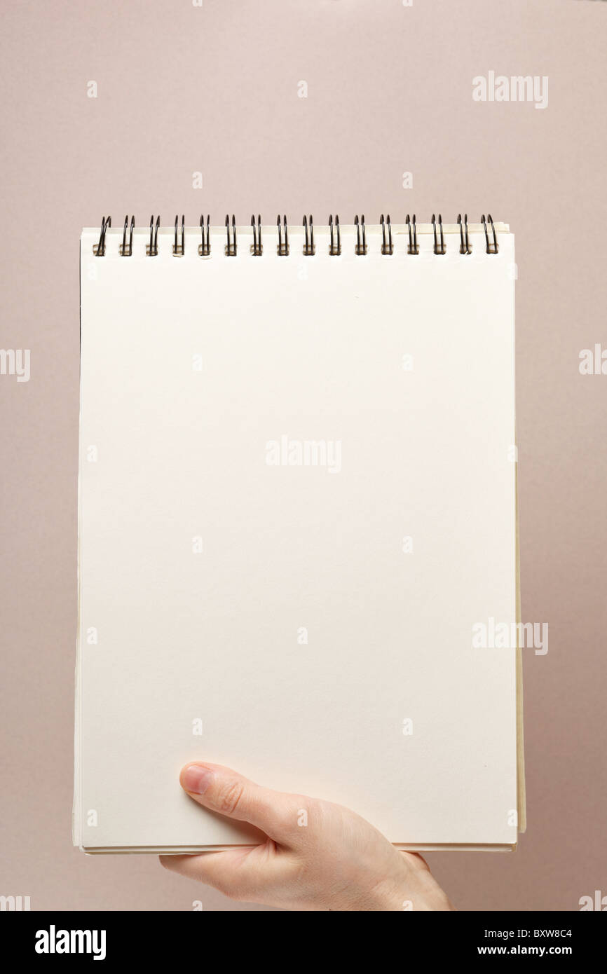 Hand holding blank notepad Stock Photo - Alamy