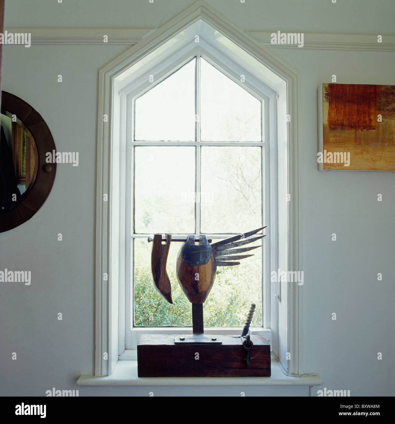 Close-up of modern statue on windowsill of apex-frame window Stock ...