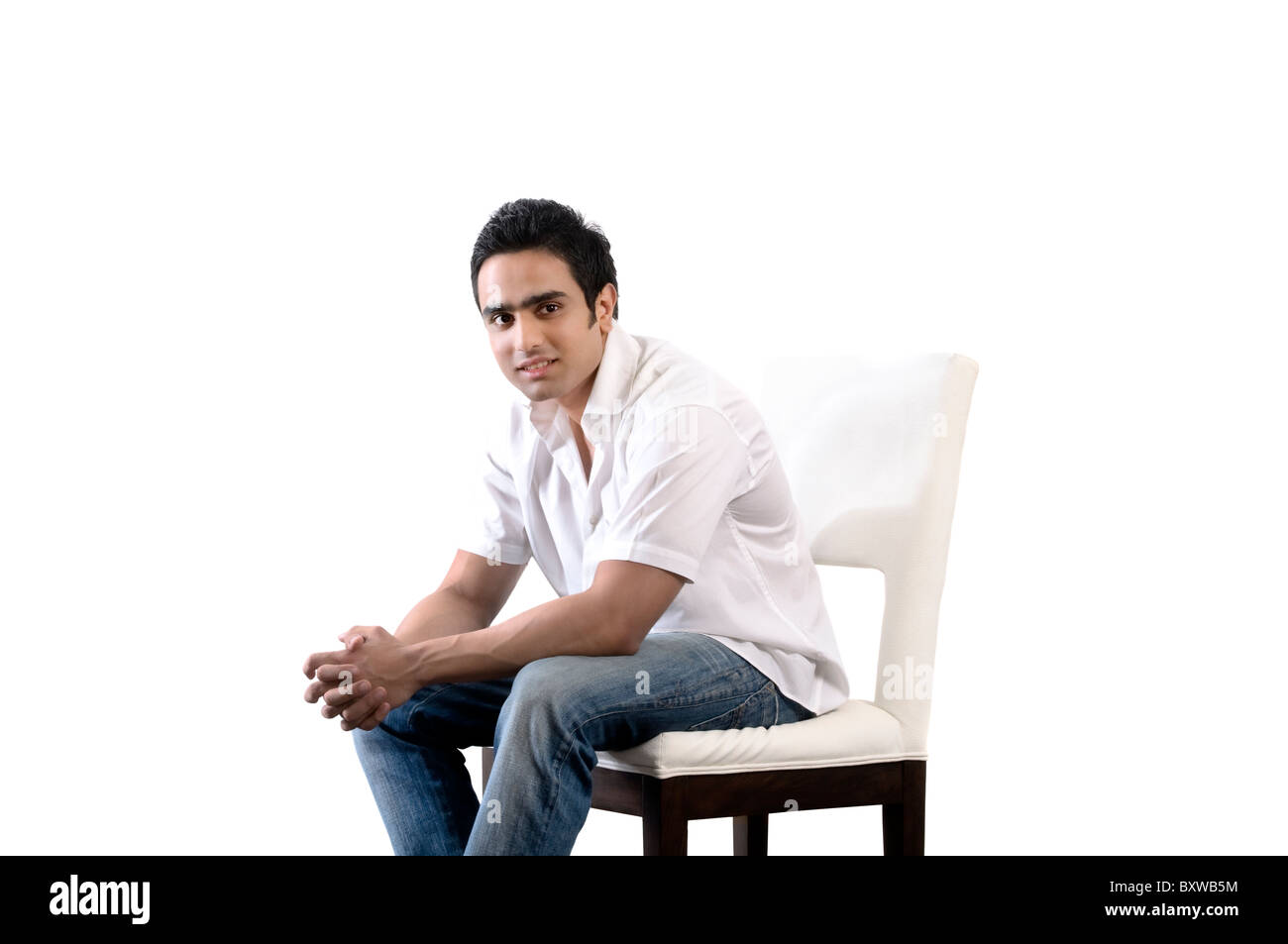 A man sitting on a chair Stock Photo - Alamy