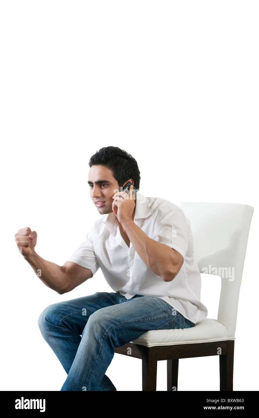 A man sitting on a chair Stock Photo - Alamy