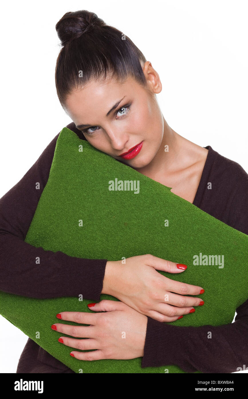 Young woman hugging cushion Stock Photo - Alamy