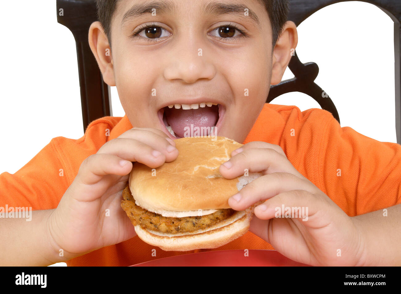 A small child having a burger Stock Photo - Alamy