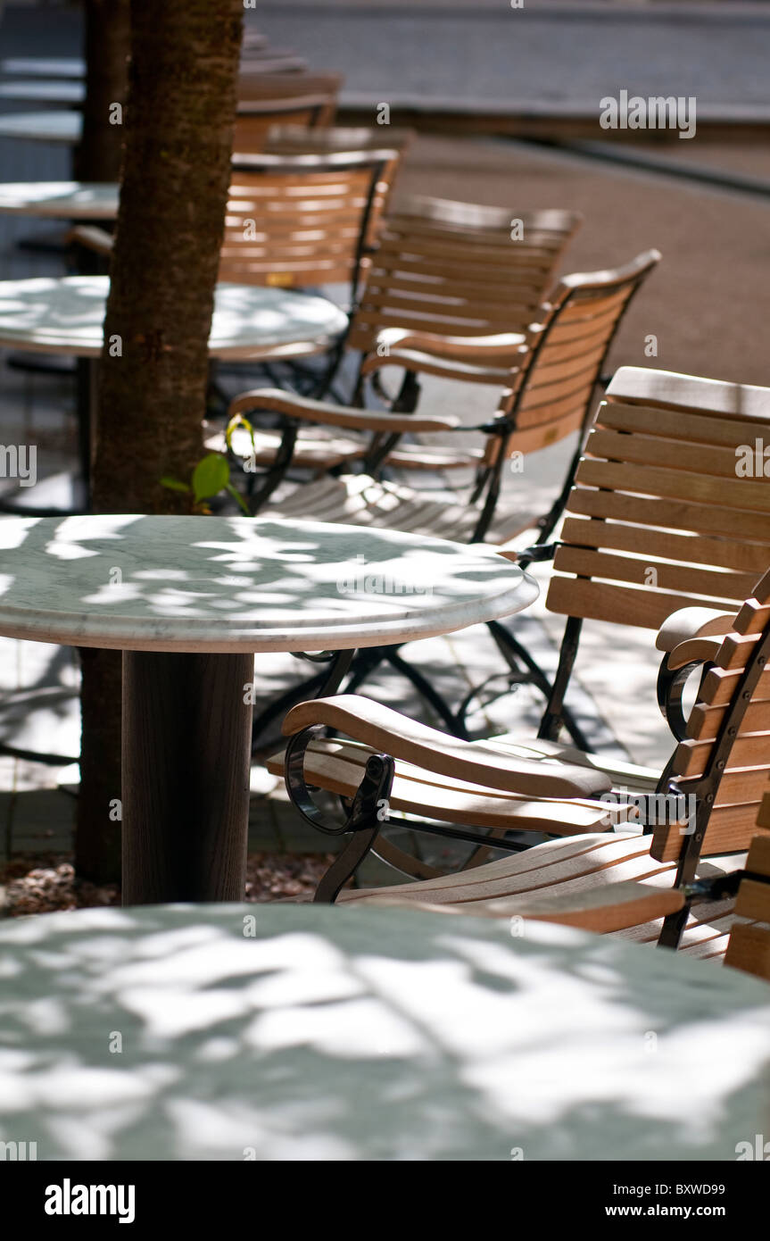 Empty tables and chairs of outdoor in dappled sunlight, UK Stock Photo ...