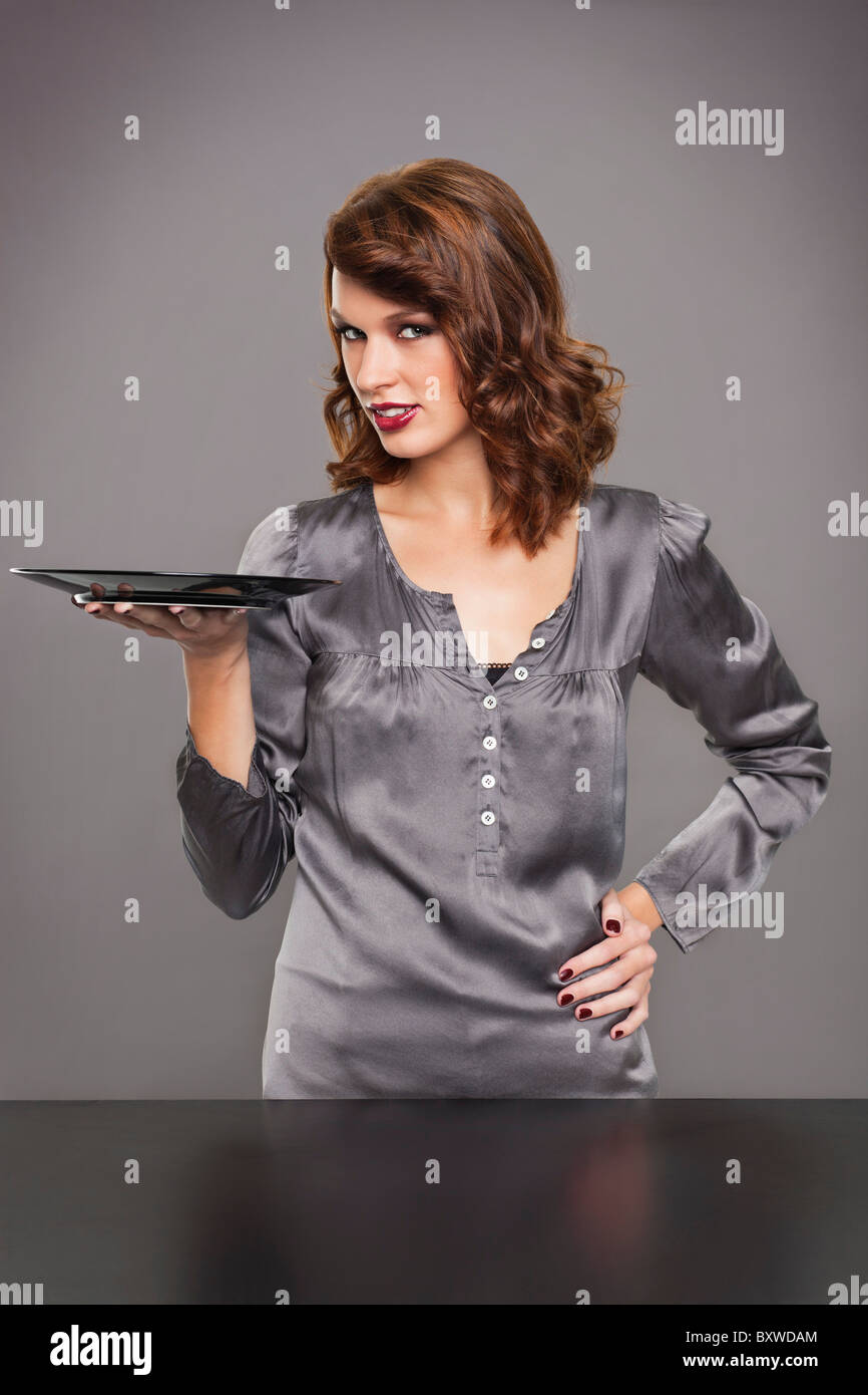 Young woman holding plate Stock Photo - Alamy