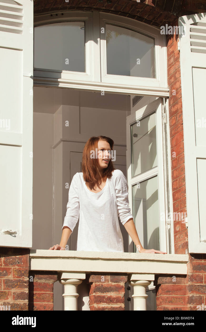 Young woman at window Stock Photo - Alamy