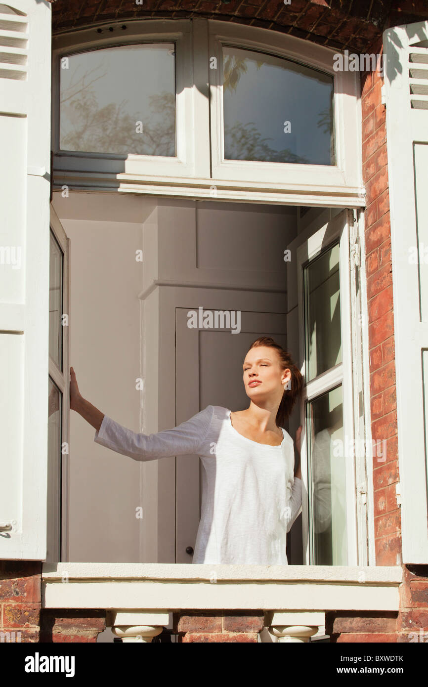 Young woman opening window Stock Photo - Alamy Young woman opening window Stock Photo - Alamy