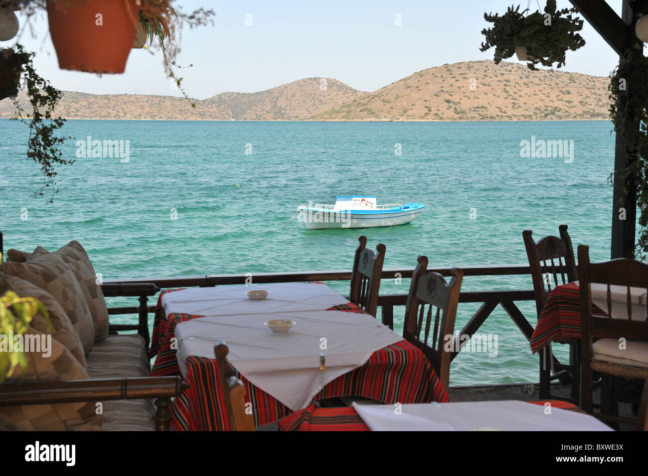 Restaurant tables overlooking the sea at Elounda in Crete Stock Photo ...
