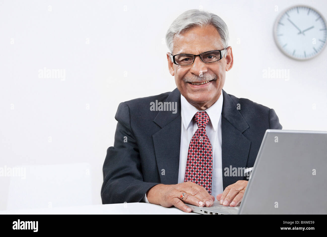 Old businessman with a laptop Stock Photo - Alamy