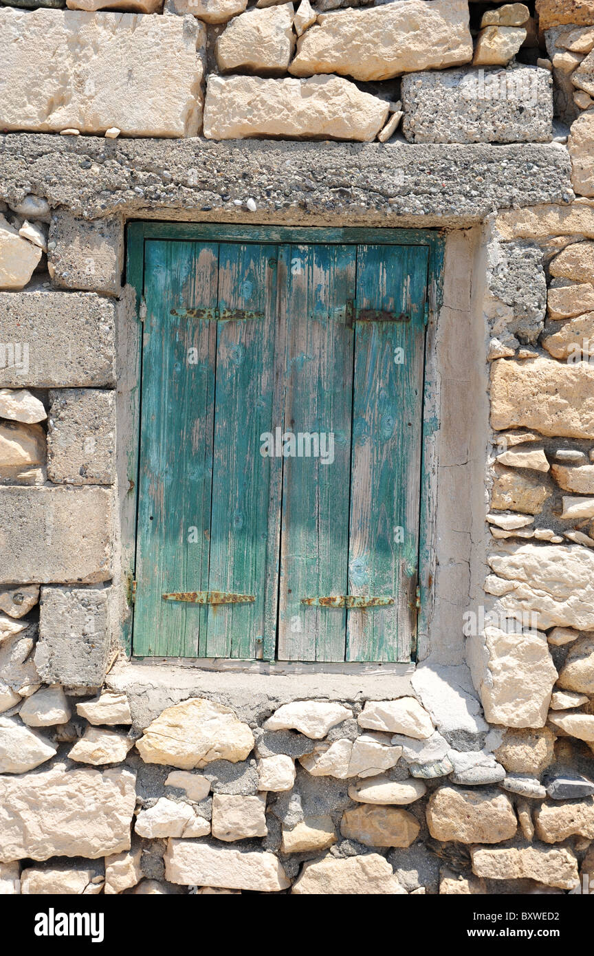 Typical Greek window with weathered shutters Stock Photo - Alamy