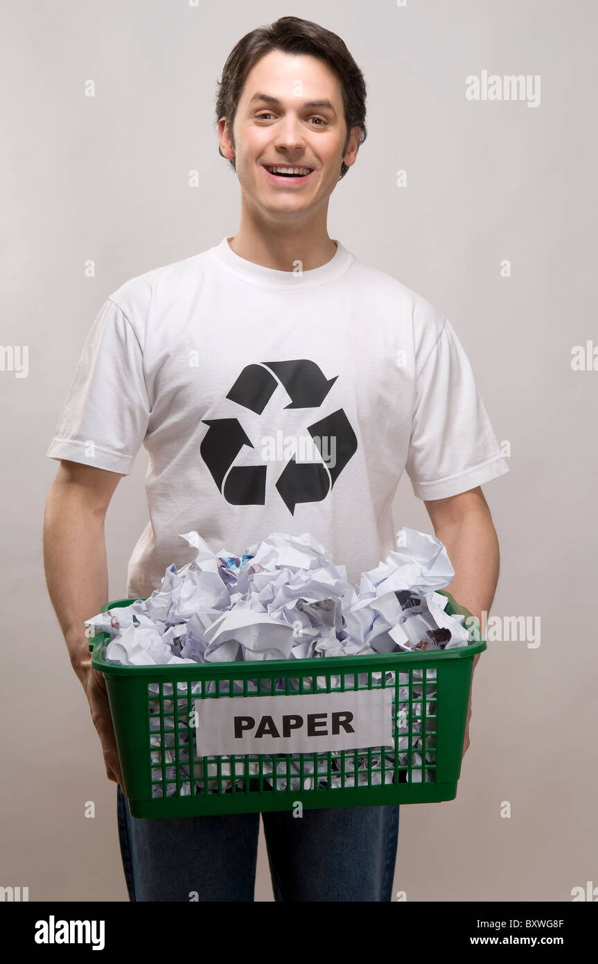 Man holding paper in a recycling bin Stock Photo - Alamy