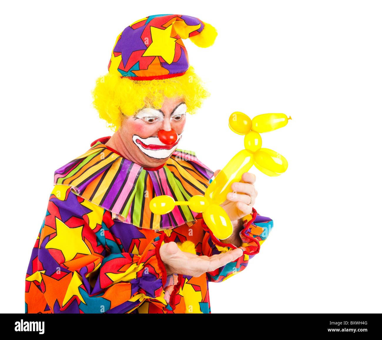 Humorous picture of a clown looking disgusted as a balloon animal poops ...