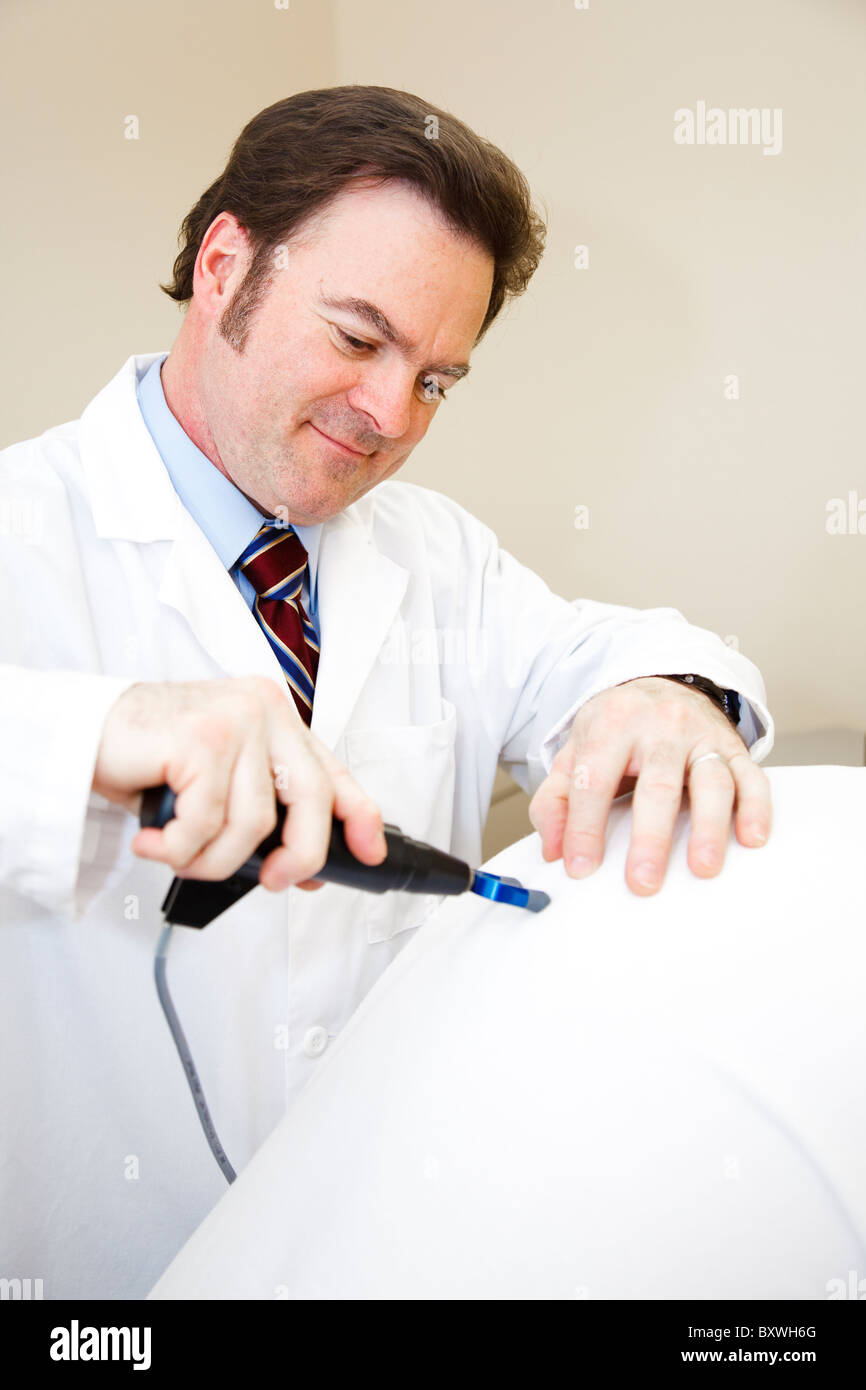Chiropractor using an electric tool to adjust a patient's spine Stock ...