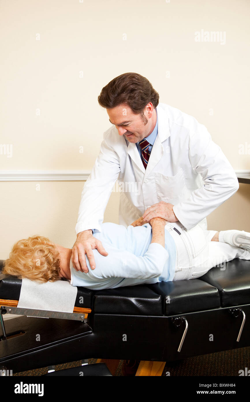 Chiropractor adjusting a patient's spine in his office Stock Photo - Alamy