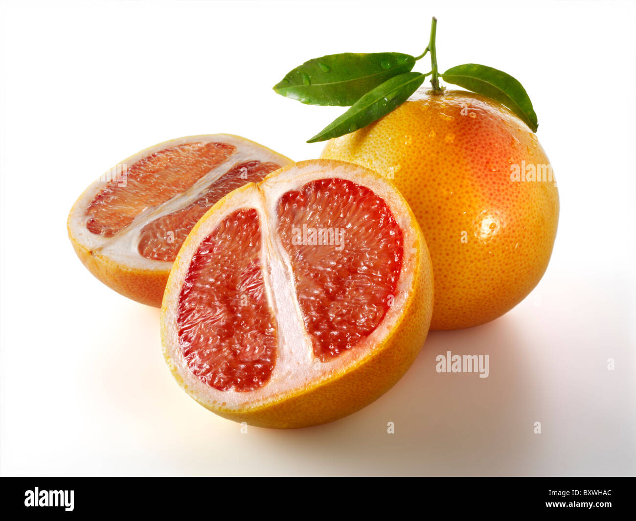 Fresh whole and cut pink grapefruit Stock Photo - Alamy