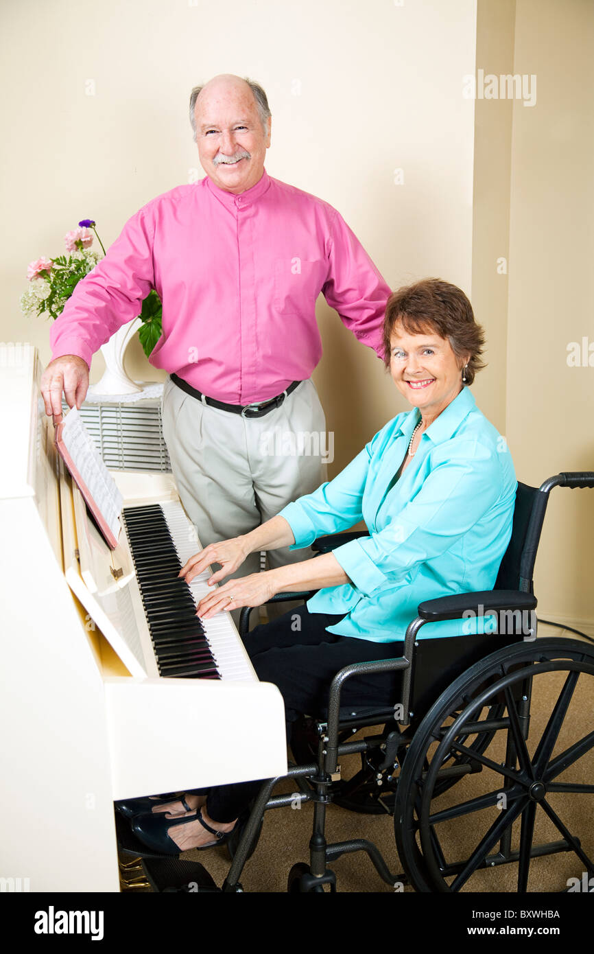 Pretty church pianist in wheelchair, playing piano while a singer turns ...