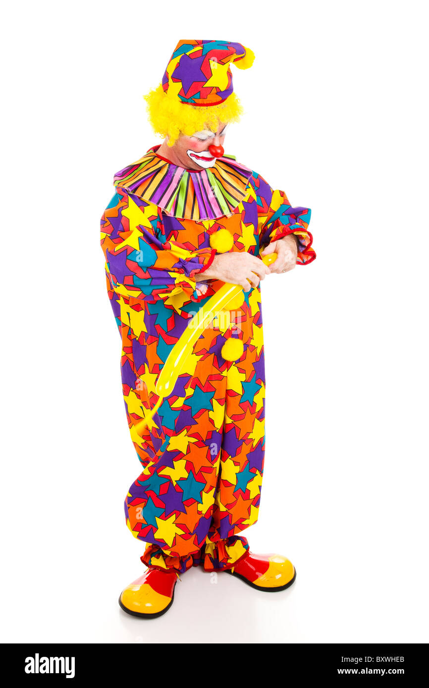 Clown twisting a balloon into the shape of an animal. Full body ...