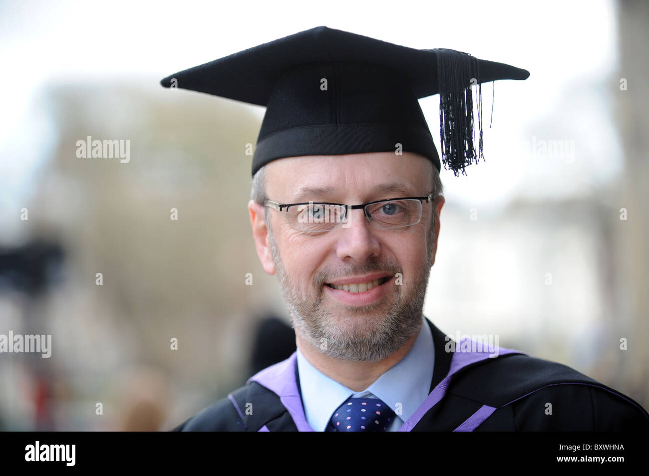 Happy smiling mature male student graduate about to pick up his degree ...