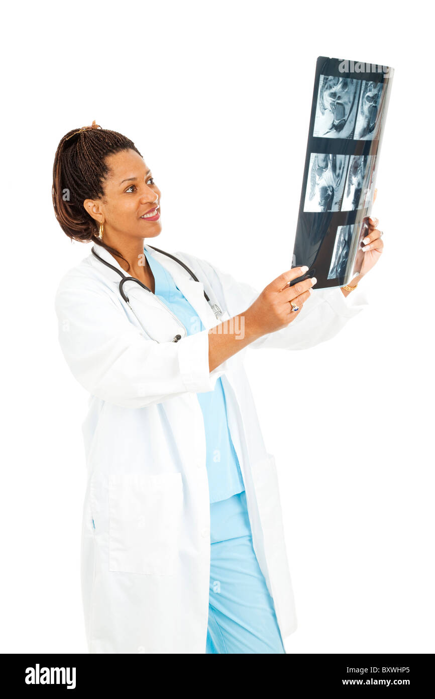 Female, african-american doctor looks at films from a CT scan. Isolated ...