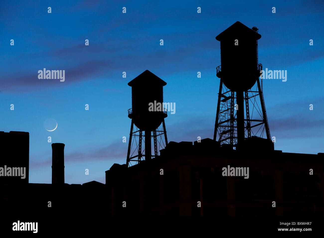 USA, New Jersey, Jersey City, Rooftop water towers and setting crescent ...
