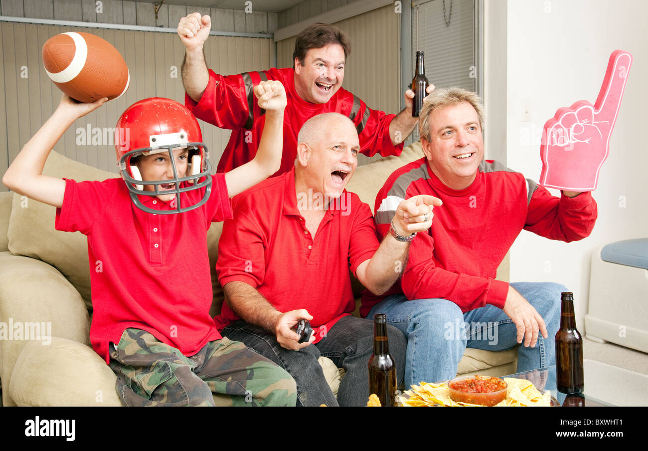 Excited football fans watching their team score a touchdown Stock Photo ...