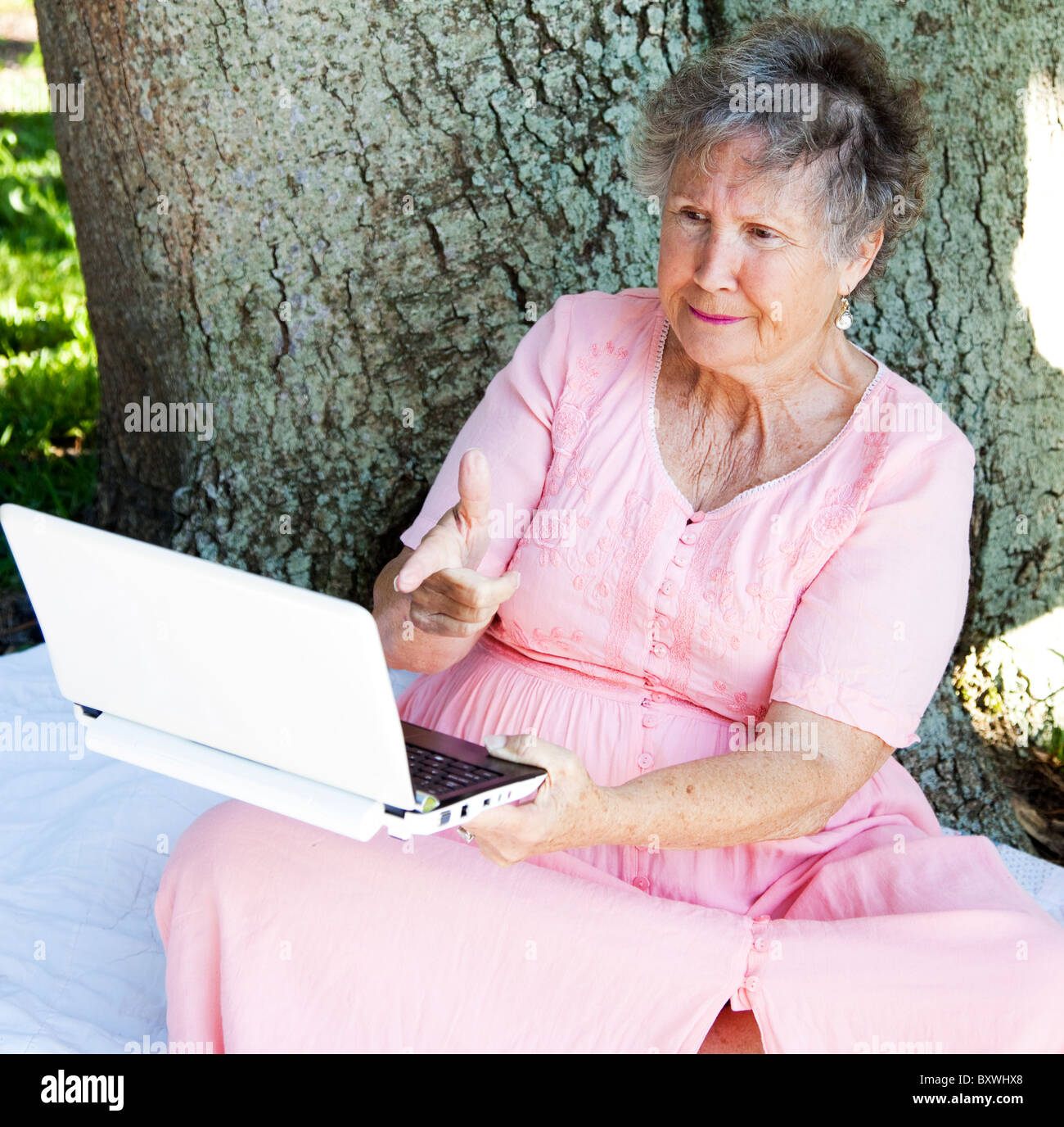 Senior woman gets frustrated trying to use her netbook computer Stock ...