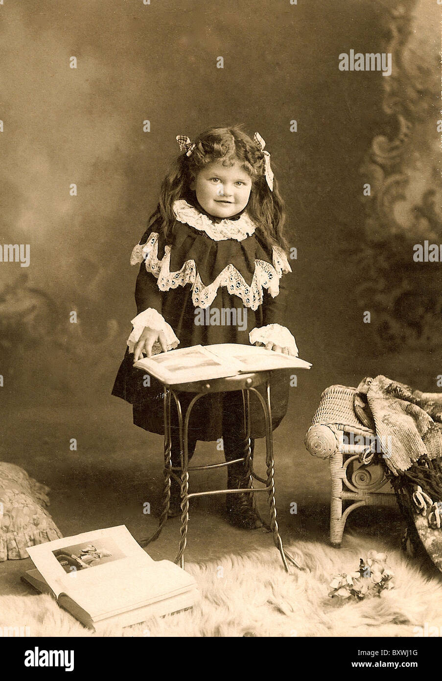 Historic image of girl reading; studio portrait, circa 1900 Stock Photo ...