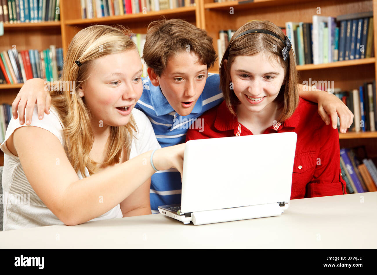 Kids in the school library, using the computer, are surprised by what ...