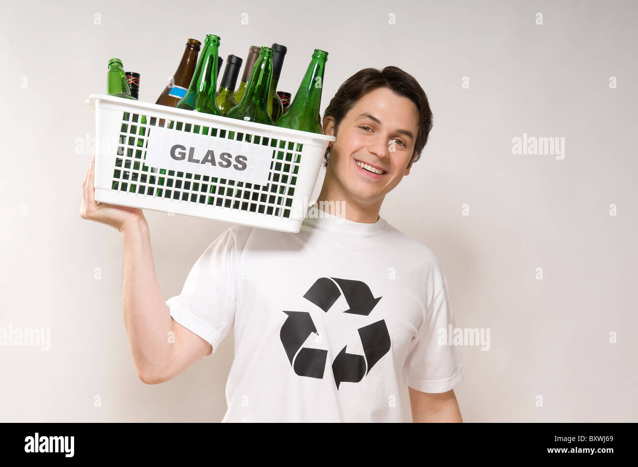 Man recycling empty bottles Stock Photo - Alamy