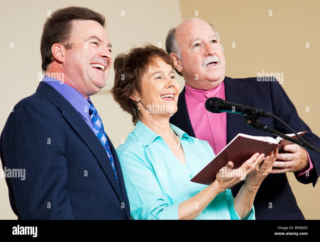 Three singers performing from the church hymnal Stock Photo - Alamy