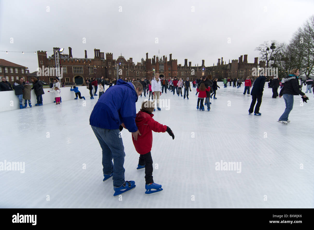 people ice skating on the winter rink at Hampton Court Palace London ...