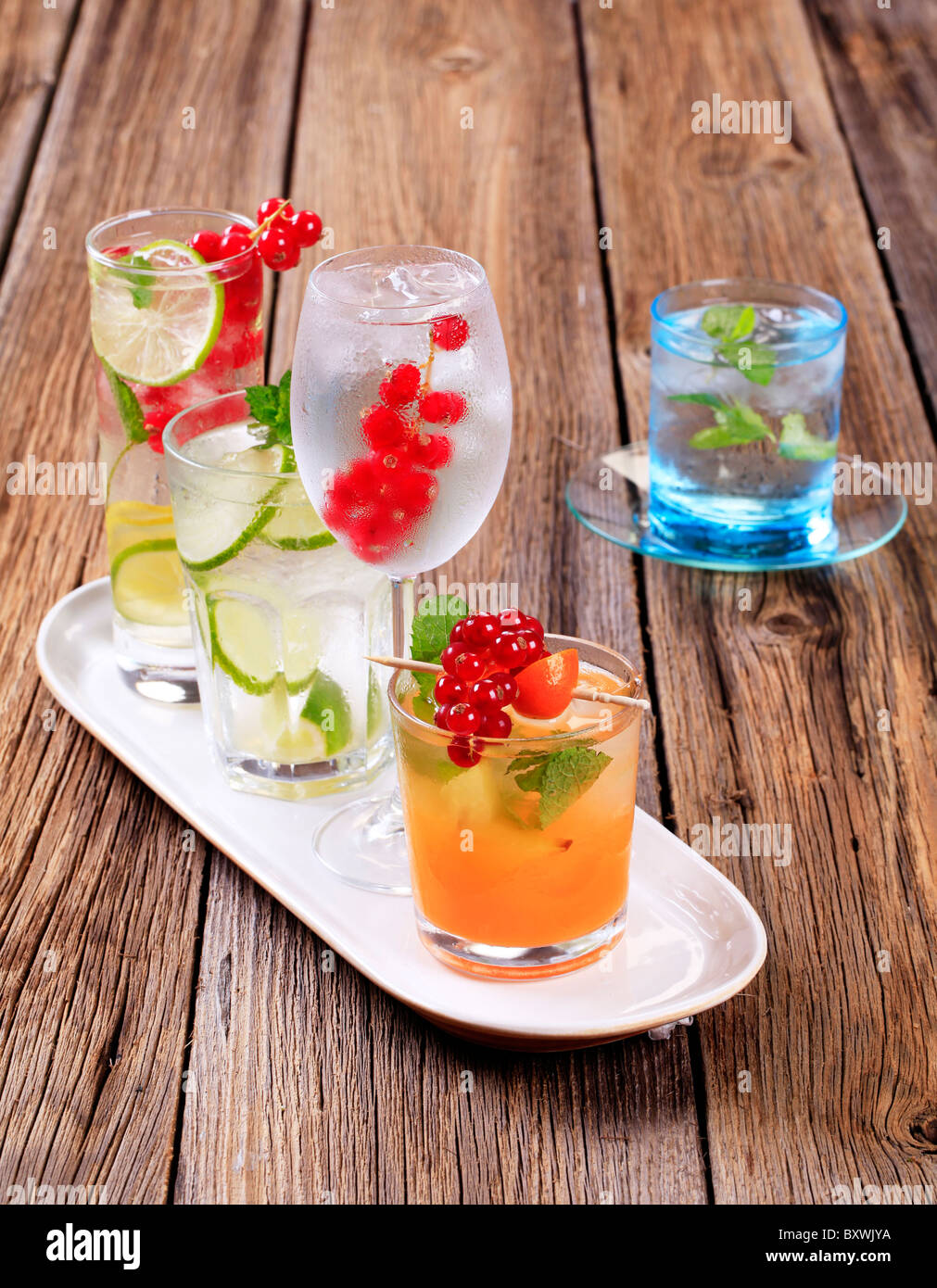 Glasses of iced drinks garnished with fresh fruit Stock Photo - Alamy