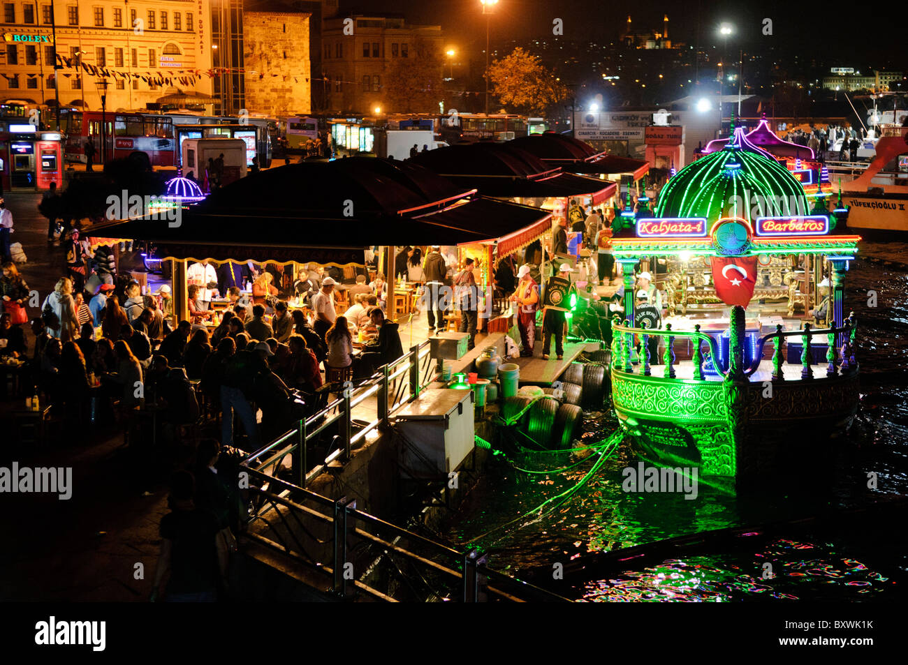 ISTANBUL, Turkey — Illuminated balik ekmek boats serve traditional fish ...