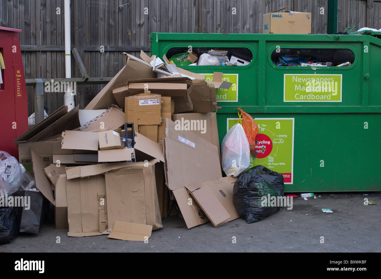 overloaded recycling facilities where people dump refuse beside skips ...
