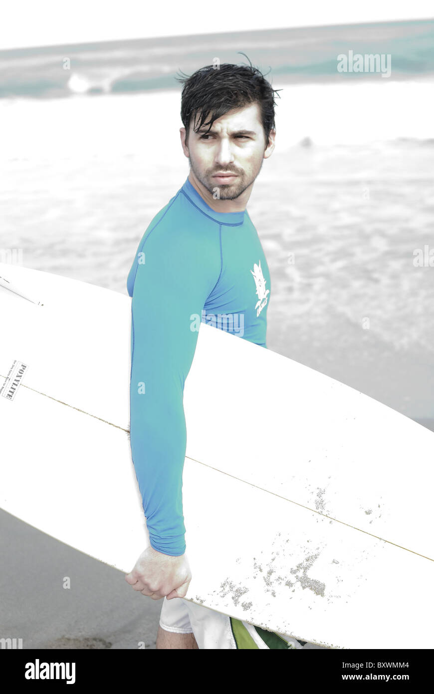 Surfer running on the beach into the ocean with his board Stock Photo ...