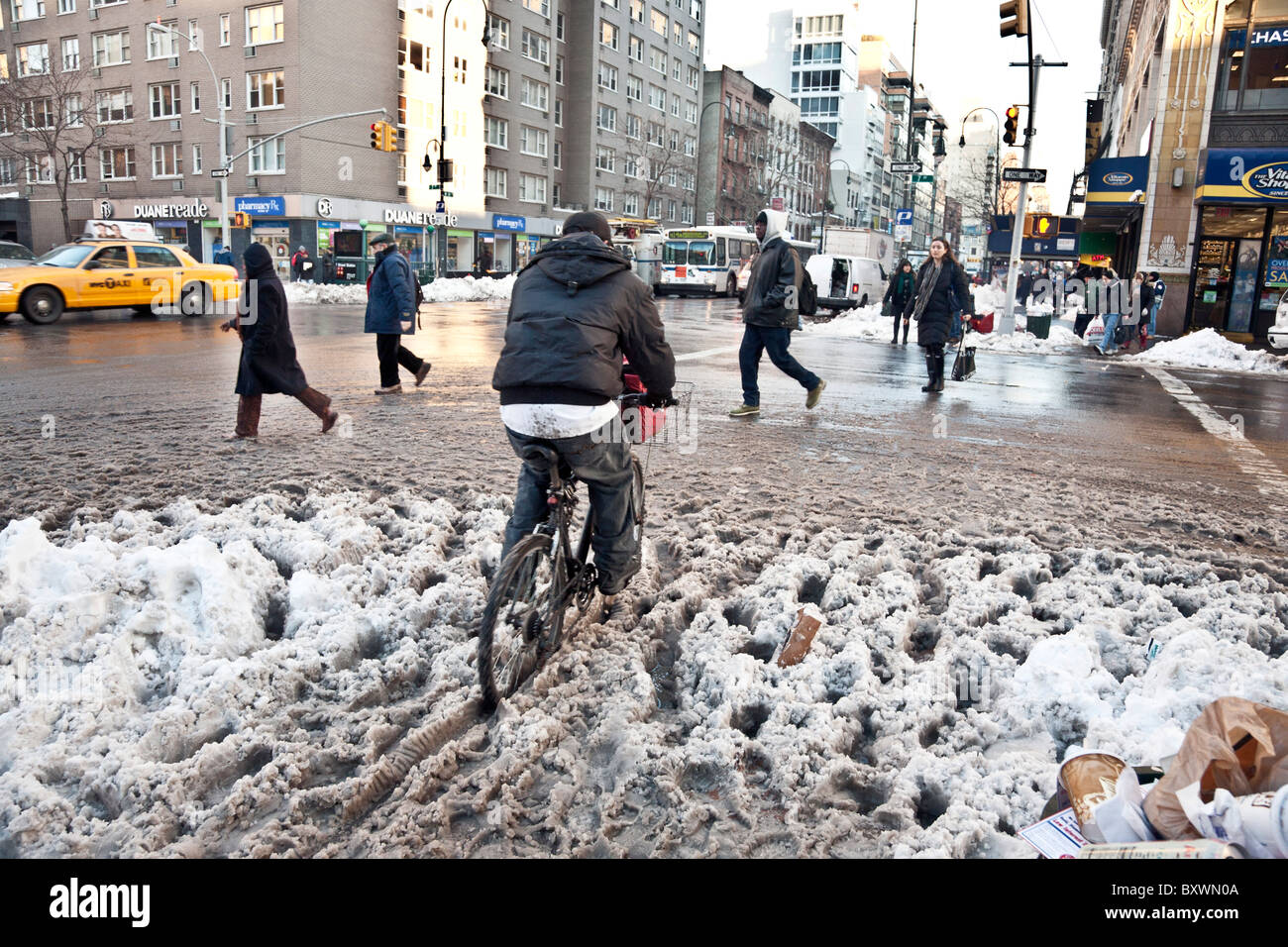 bicyclist zooms through street corner slush on 14th street left by ...