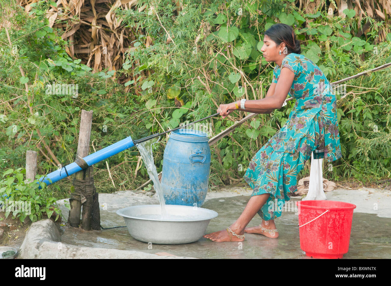 portrait of an Indian woman washing clothes at a homeless camp in ...