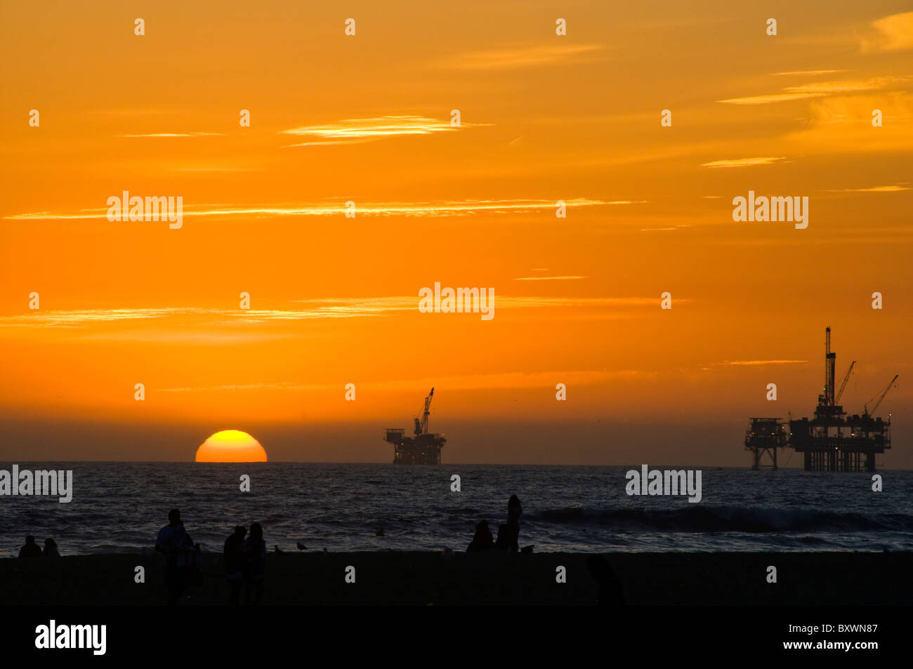 Offshore oil rigs at sunset in Pacific ocean Stock Photo - Alamy