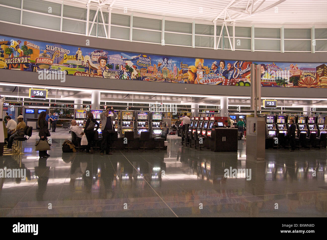 Slot machines and a mural depicting famous Las Vegas landmarks and ...