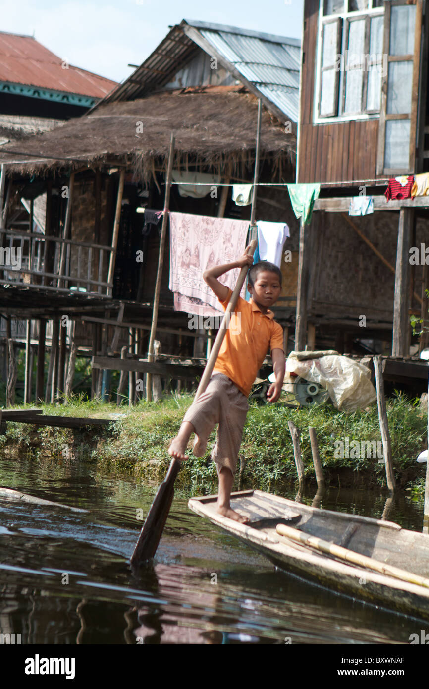 boy rowing with foot on the inle lake Stock Photo - Alamy