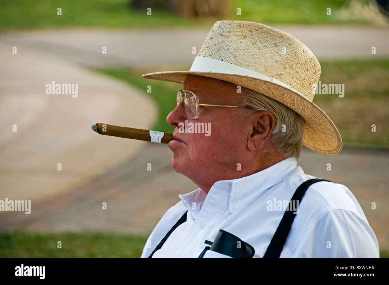 Elderly southern looking gentleman smoking a cigar in plaza in Santa Fe ...
