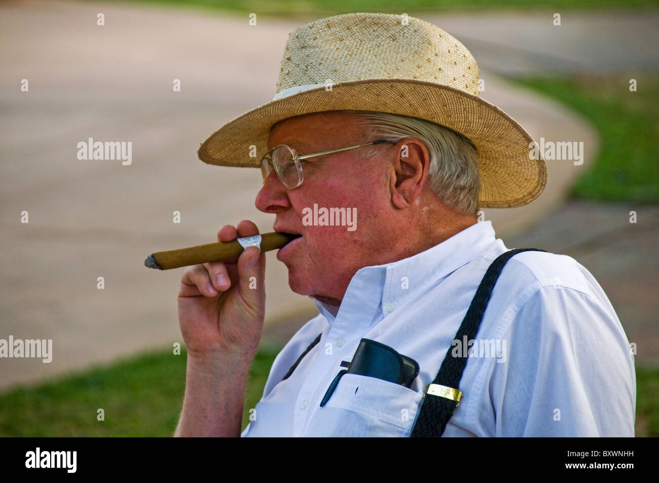 Elderly southern looking gentleman smoking a cigar in plaza in Santa Fe ...