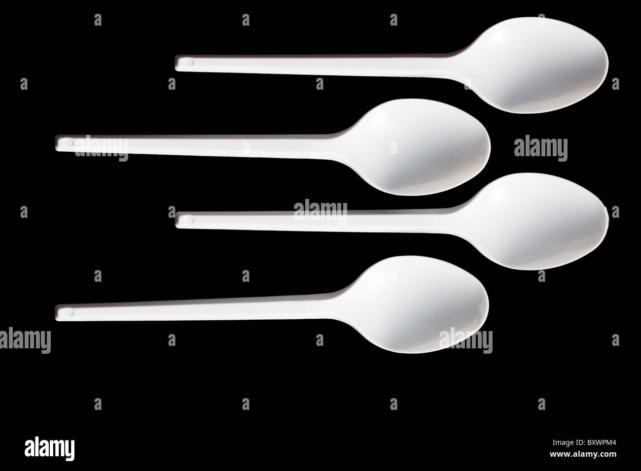 the plastic spoons on black background Stock Photo - Alamy