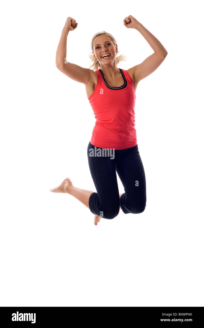 Excited young woman jumping isolated over a white background Stock ...