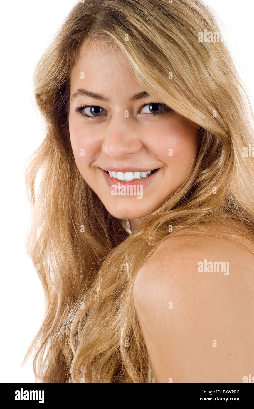 Smiling woman looking over her shoulder at camera isolated over white ...